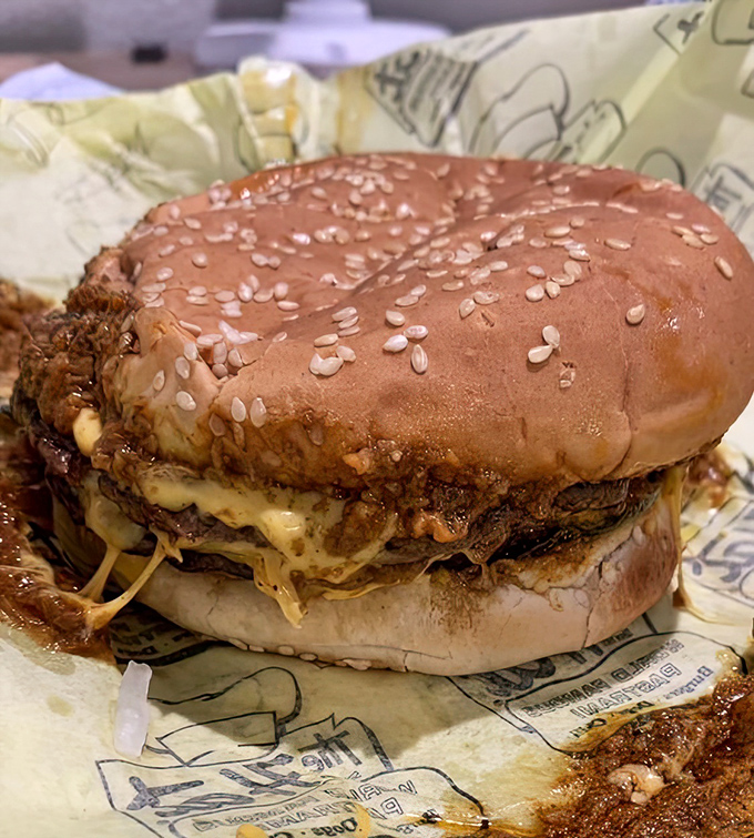 This burger defies both gravity and restraint. The melted cheese cascades down the sides like a delicious waterfall of indulgence.