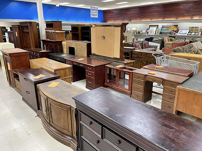 Wooden desks and drawers stand like sentinels of craftsmanship from an era when furniture was built to outlast its owners.