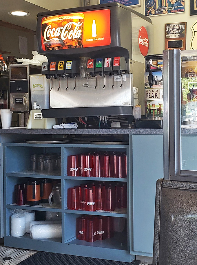 The soda fountain stands ready to dispense liquid happiness, with those classic red cups waiting to complete your meal.