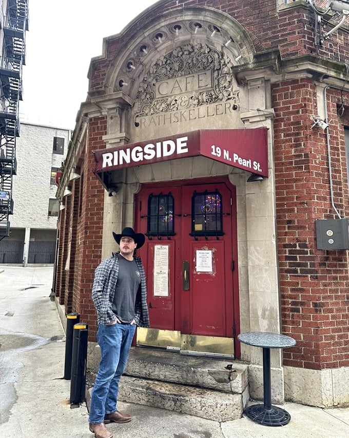 The stone archway proudly announces "CAFE" and "RATHSKELLER," hinting at the building's storied past. That red door has welcomed hungry Ohioans for generations.