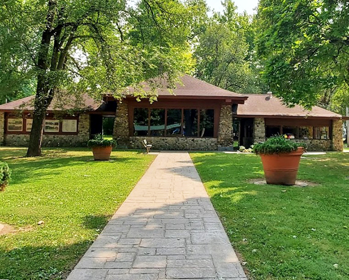 The stone visitor center welcomes guests with that classic "park architecture" vibe that somehow manages to be both rustic and dignified, like a lumberjack in a tuxedo.