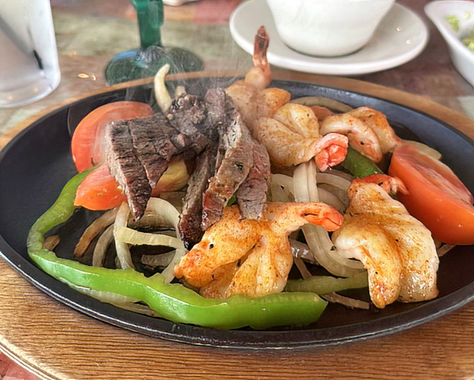 Sizzling fajitas arrive with that theatrical steam that turns every head in the restaurant – beef and shrimp playing the delicious co-stars.