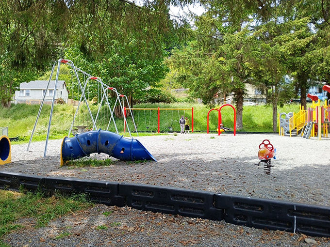 Fireman's Park playground stands ready for grandkid visits, where swings still work like time machines to simpler days.