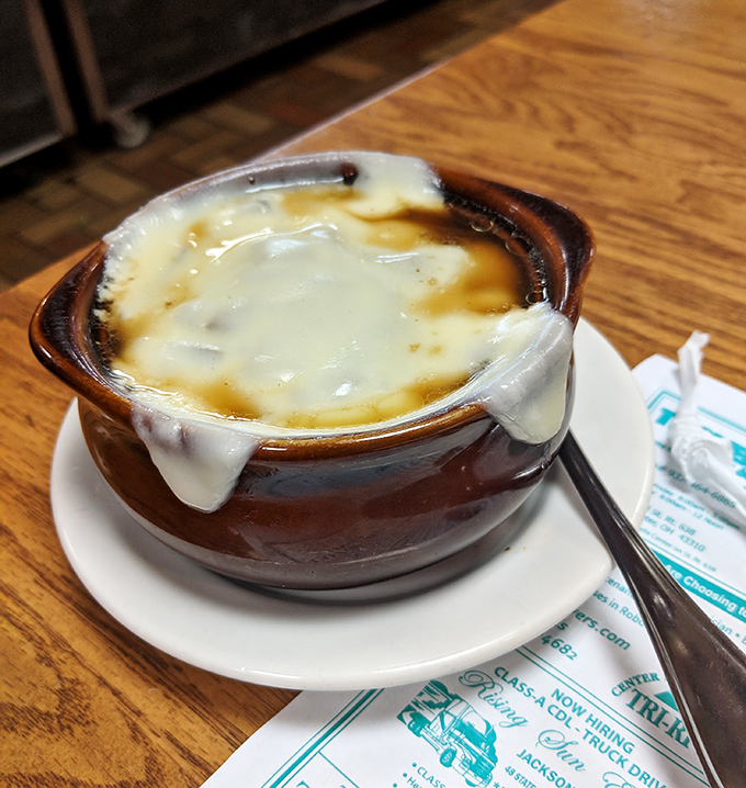 French onion soup with cheese stretching to the heavens&mdash;a bowl of savory comfort topped with a golden crown of broiled perfection.