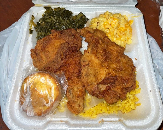 Fried pork chops with collards and mac and cheese - the kind of plate that makes conversation stop and appreciative head-nodding begin.