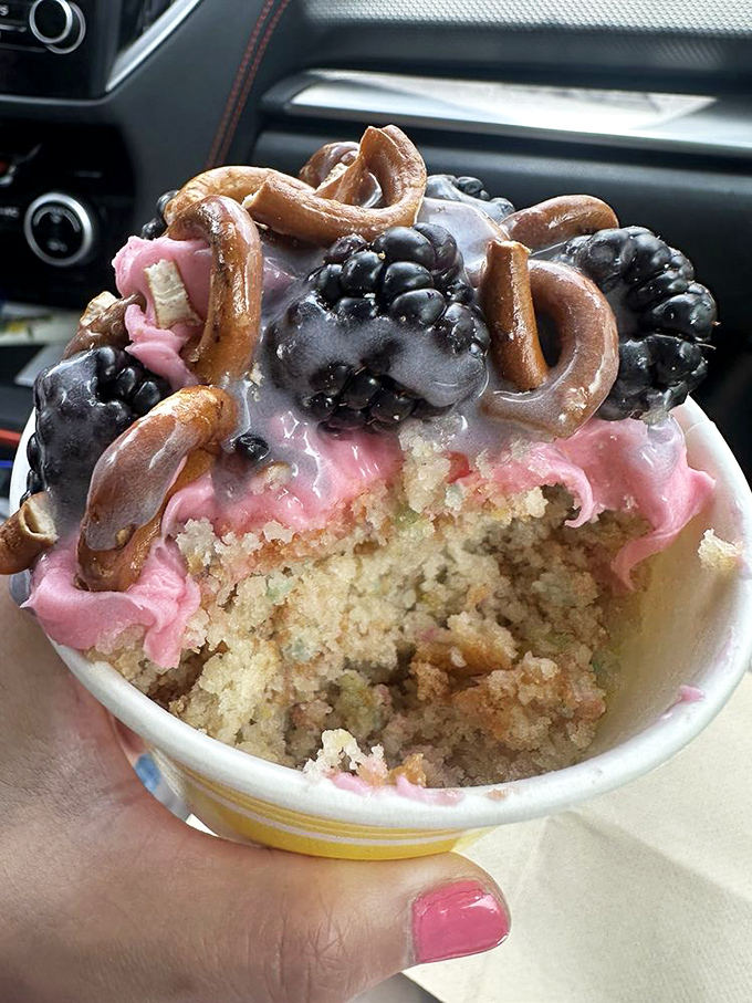 Car dashboard dining: the true test of a portable dessert. This pink frosted cup with pretzels and berries turns traffic jams into impromptu cake parties.