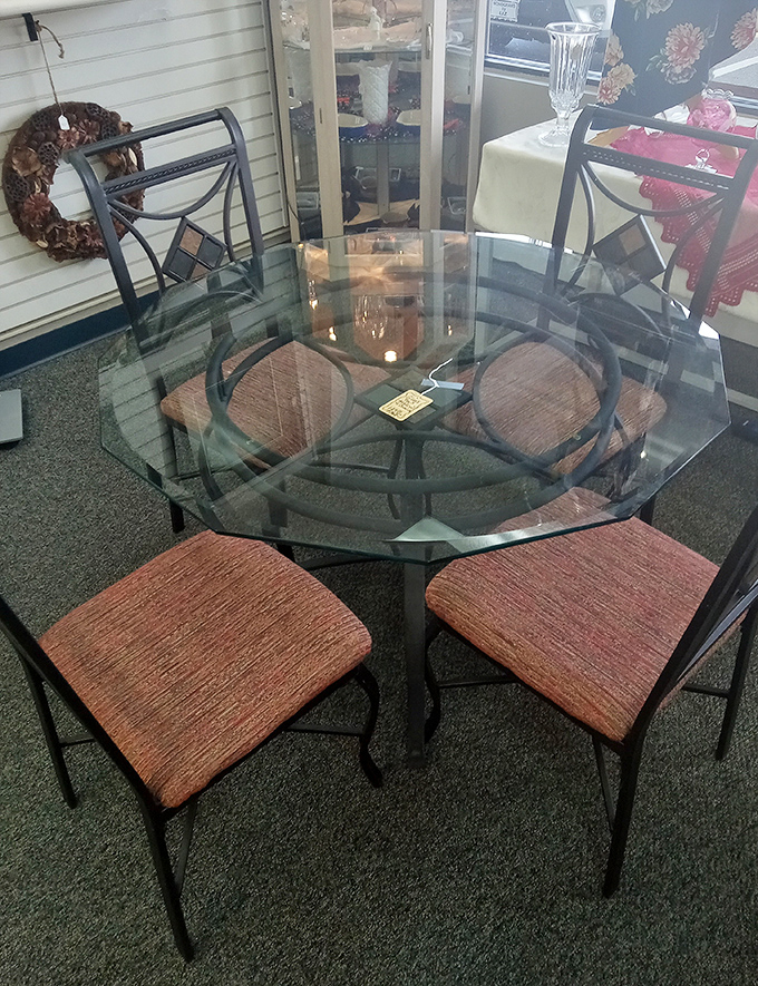 This elegant glass dining set with coordinating chairs would cost a small fortune new but waits patiently here for its next dinner party.