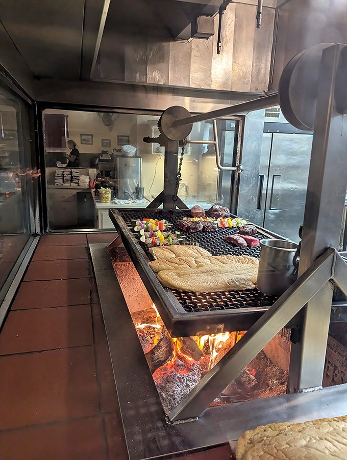 The grill itself—a custom-built altar where oak wood transforms into glowing coals and simple ingredients become transcendent meals through fire, skill, and time.