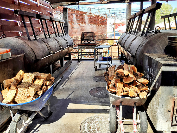 The holy grail of BBQ: massive smokers flanked by post oak wood. This is where the magic happens, one patient hour after another.