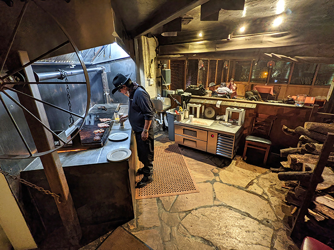 Where the magic happens: a chef tends the mesquite grill, transforming raw ingredients into the stuff of dinner table legends. Smoke whisperer at work.