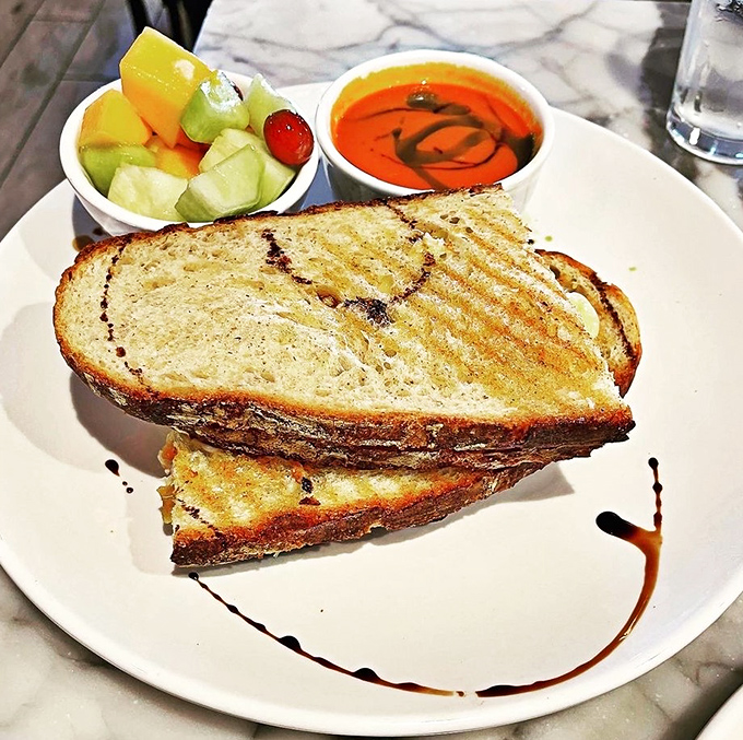 Grilled cheese elevated from childhood memory to grown-up indulgence. That tomato soup isn't just a side&mdash;it's a perfect dance partner.