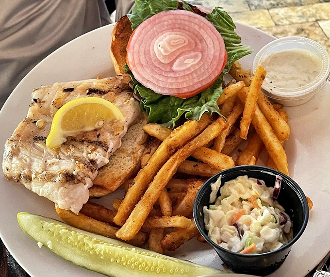 A fish sandwich that makes land-lubber options seem pointless. That pickle stands guard like it knows how special this moment is. 