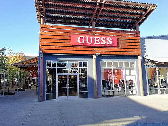 Guess tempts with bold red sale signs, proving that designer denim doesn't require designer prices when you know where to shop. 