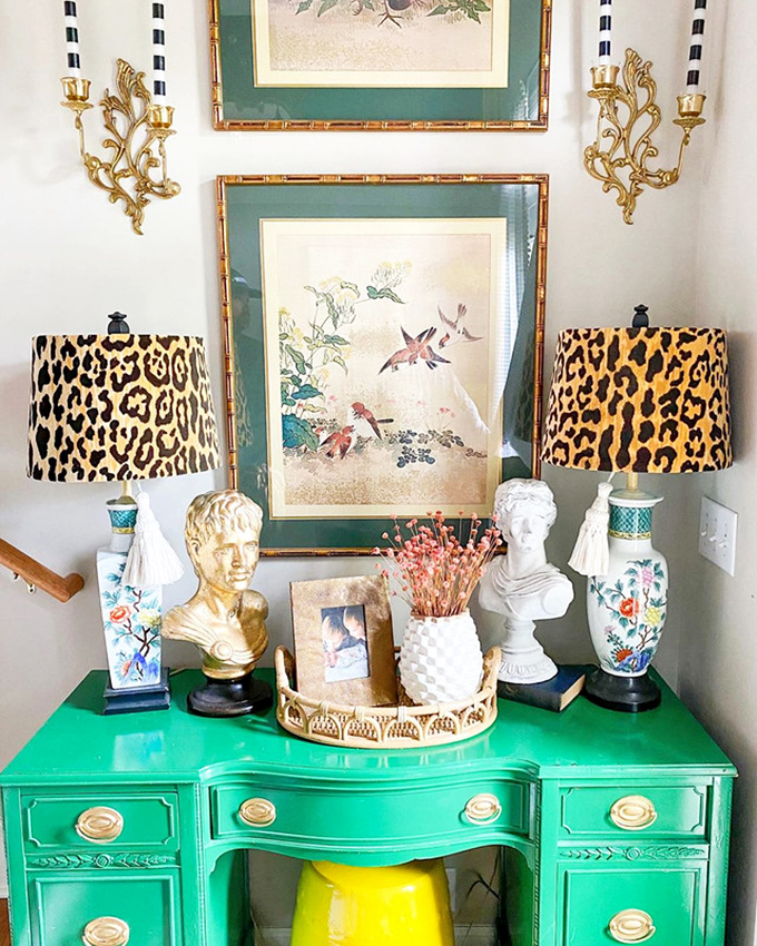 That emerald desk isn't just furniture—it's the statement piece your home office has been crying out for, complete with leopard lamp flair.