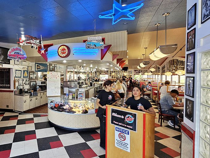 Blue neon stars illuminate the ceiling like a retro galaxy, while staff navigate the cosmos of comfort food below.