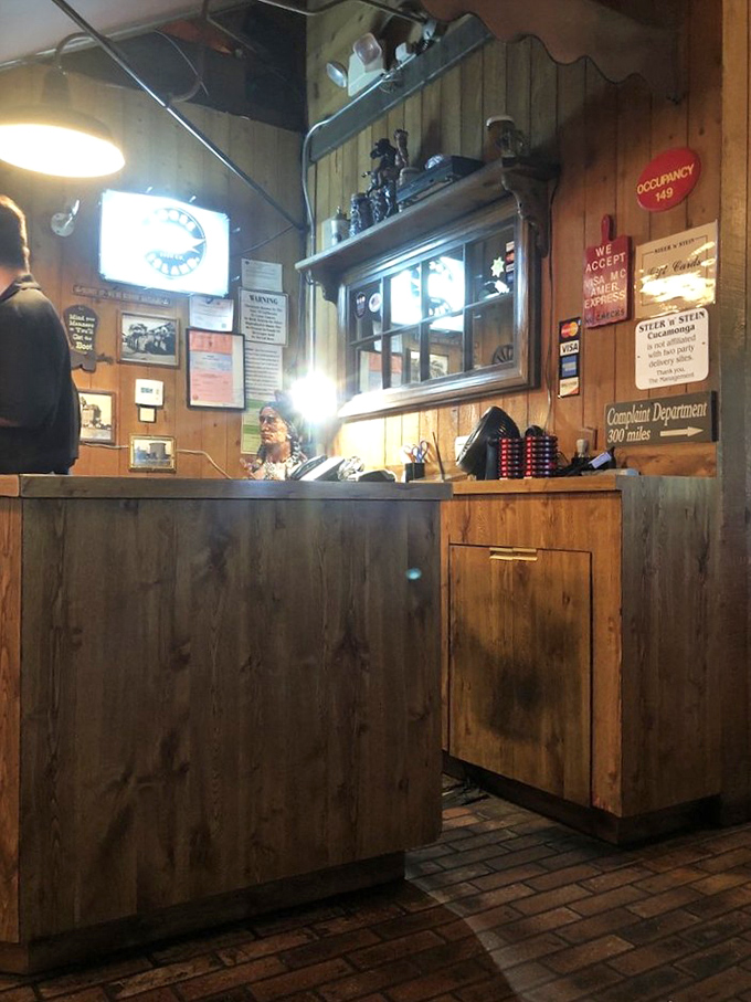 The host station&mdash;wood-paneled and welcoming&mdash;where your journey into steak nirvana officially begins with a friendly greeting.