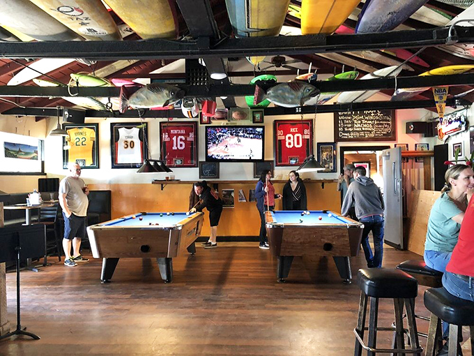 Pool tables and sports memorabilia create the perfect playground for adults who still know how to have fun between bites.