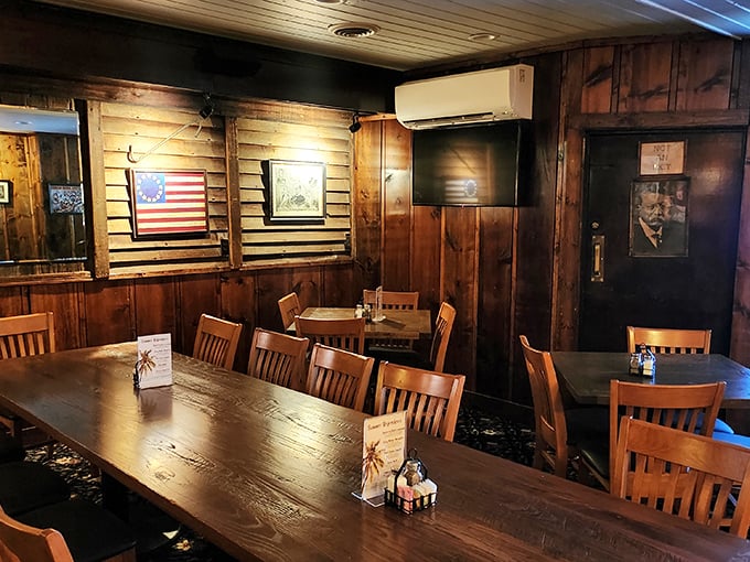 A private dining area where family-style tables invite lingering conversations. The wooden walls have absorbed decades of celebration toasts and birthday songs.