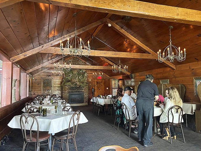 Exposed wooden beams and stone fireplace create the quintessential Northwoods dining atmosphere—like eating in a luxurious cabin built just for feasting.
