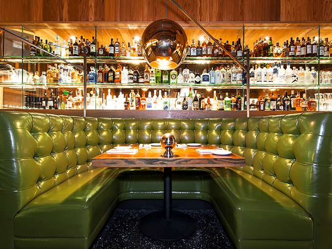 This booth isn't just seating&mdash;it's a private sanctuary where important decisions are made, like whether to order a second cocktail.