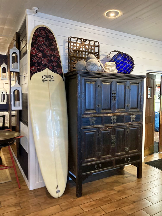 Surfboards and antique cabinets create that "beach house your cool aunt inherited" vibe that makes you want to kick off your flip-flops.