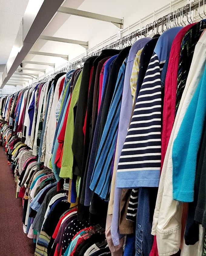 The clothing racks stretch toward infinity, a textile galaxy where fashion trends of every decade collide in harmonious chaos.