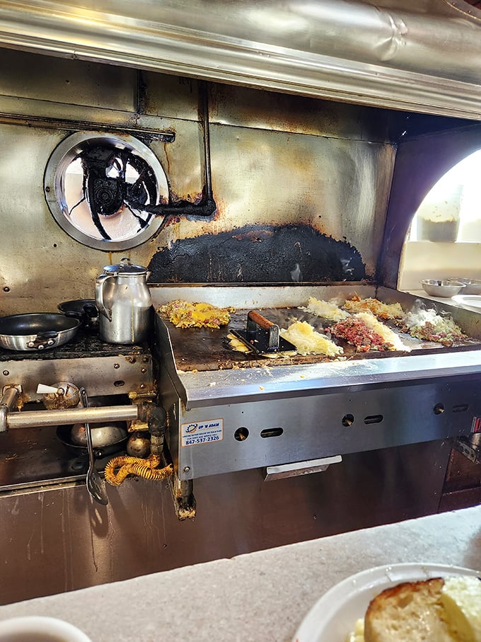 The well-seasoned flattop&mdash;where breakfast dreams come true and diet plans go to die. That patina isn't grime; it's a century of flavor development.