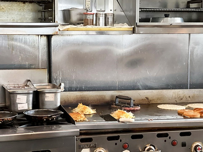 Behind the scenes where breakfast magic happens. That flat-top grill has seen more action than an action movie stunt double.