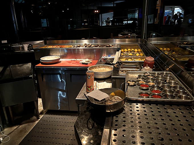The kitchen's organized chaos reveals the military precision behind your seafood bliss. This is where the magic happens, minus the smoke and mirrors.