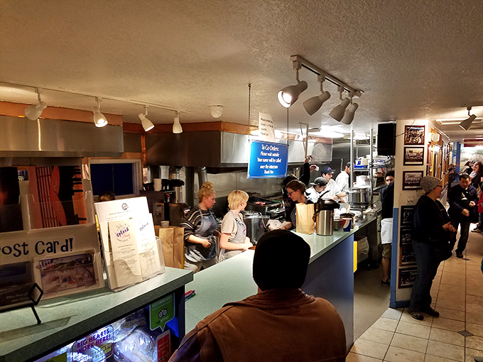 Behind the blue counter, culinary magic happens with the efficiency of a well-rehearsed dance and the passion of true seafood believers.