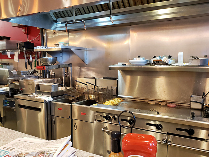 A gleaming kitchen that means business. That flat-top grill has probably seen more action than most Broadway stages.