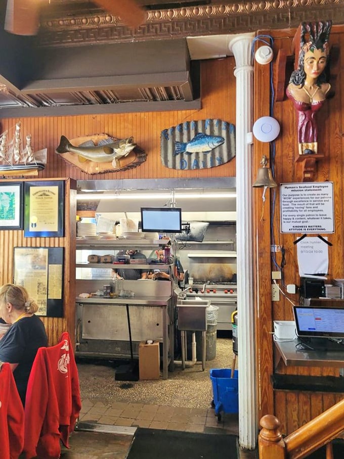 Behind these wooden walls, culinary magic happens amid mounted fish that seem to approve of their seafaring cousins' delicious fate.