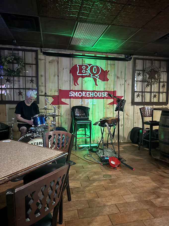 Live music and barbecue—a pairing as natural as brisket and beer. The wooden backdrop isn't just decor; it's setting the stage for a full sensory experience.