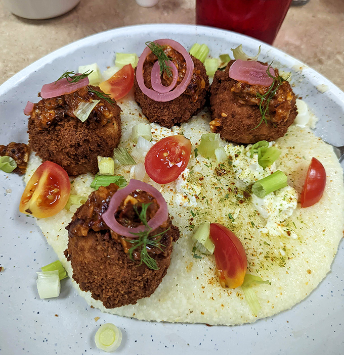 These aren't your grandma's grits&mdash;unless your grandma topped hers with seasoned meatballs, pickled onions, and fresh herbs.