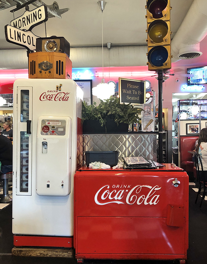 Vintage Coca-Cola machines and traffic lights create the perfect backdrop for the "Please Wait To Be Seated" sign that's rarely without purpose.