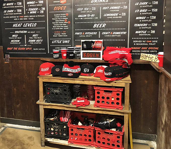 The merchandise wall says what we're all thinking: "I survived Hattie B's hot chicken and all I got was this awesome t-shirt."