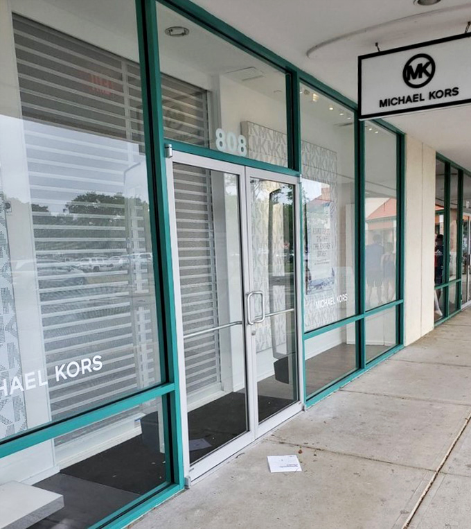 Michael Kors: Where luxury handbags wait behind glass like museum pieces, except you can actually take these home.