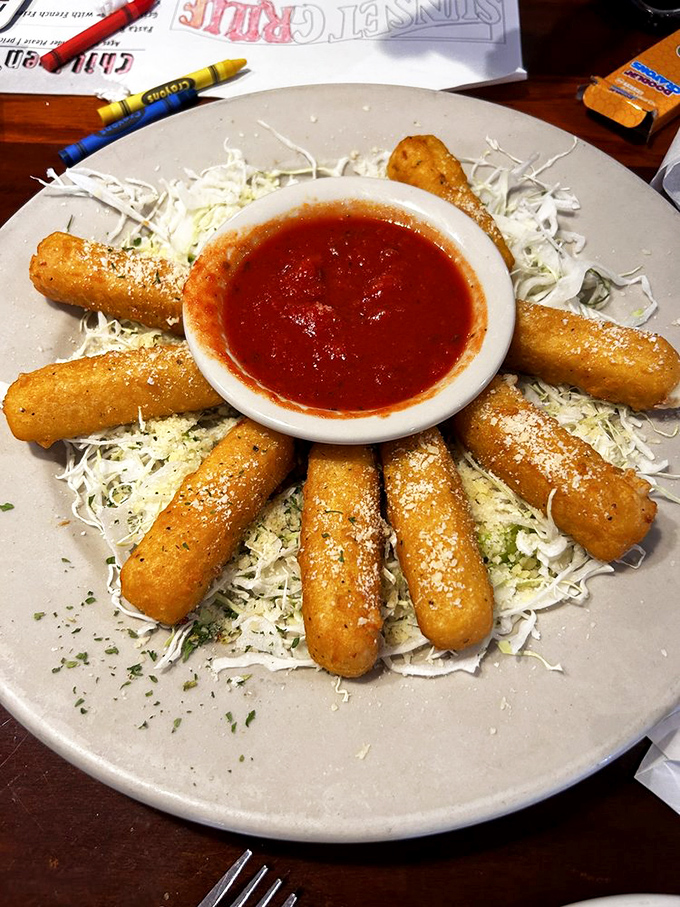 Mozzarella sticks arranged like a sunburst around marinara &ndash; proof that sometimes the simplest appetizers deliver the most satisfaction.