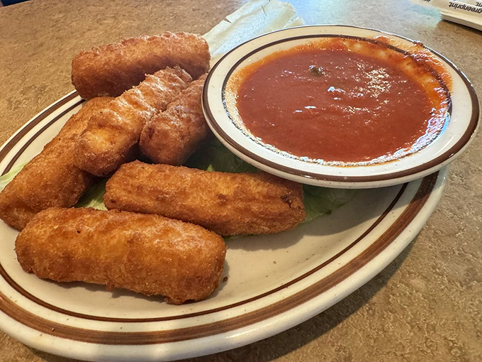 Mozzarella sticks with that perfect pull-apart cheese stretch that food photographers dream about. Marinara sauce standing by for the perfect dunk.