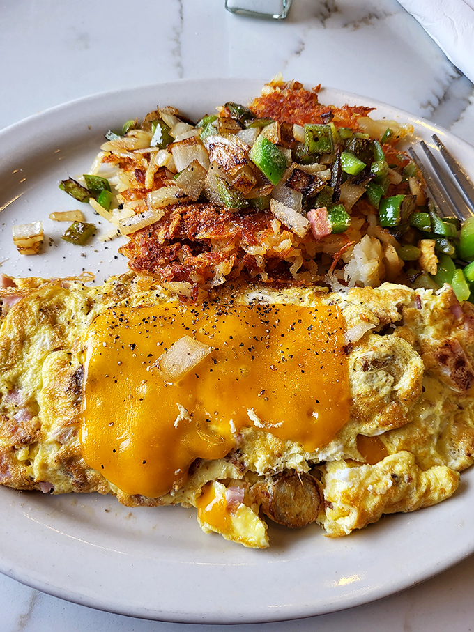 This omelet has achieved the impossible &ndash; perfectly cooked eggs embracing melted cheese alongside potatoes that are basically hash brown royalty.