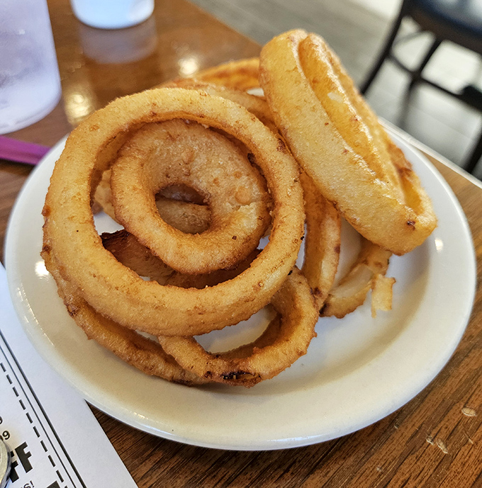 Onion rings with the perfect crunch-to-softness ratio. Each bite is like a tiny round high-five for your taste buds. 