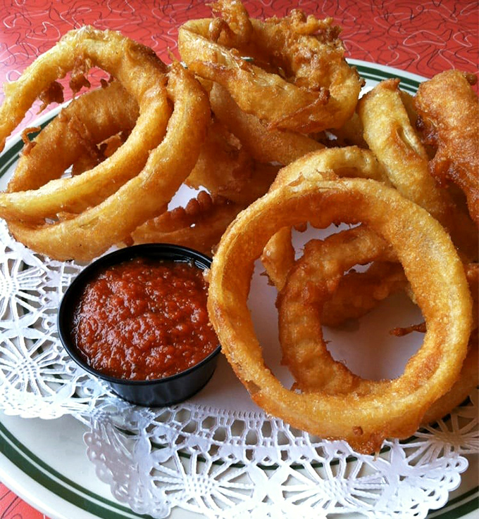Onion rings that achieve the impossible: perfectly crisp exteriors giving way to sweet, tender onion within&mdash;the golden halos of the comfort food world.