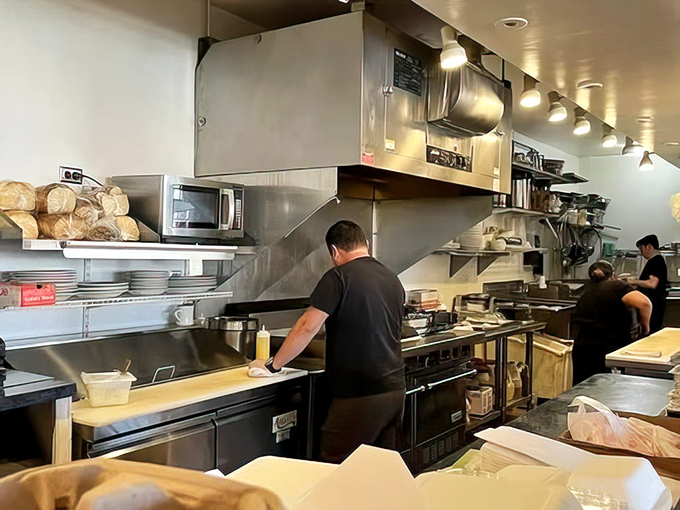 The open kitchen reveals the choreography behind your breakfast&mdash;skilled hands transforming simple ingredients into morning masterpieces.