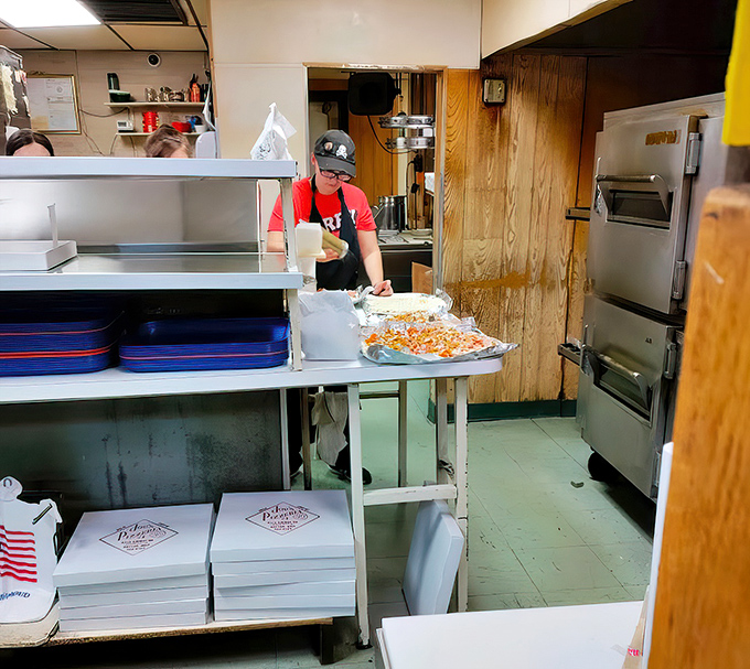 A glimpse into the kitchen reveals the pizza wizardry happening behind the scenes, where dough becomes art and hunger meets its match.