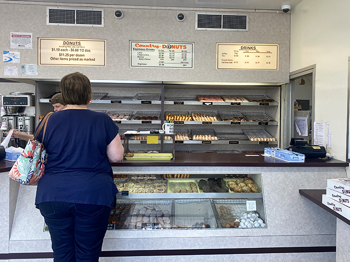 The moment of decision at the counter. Like standing before the Sistine Chapel of sugar, but you get to take pieces home in a box.