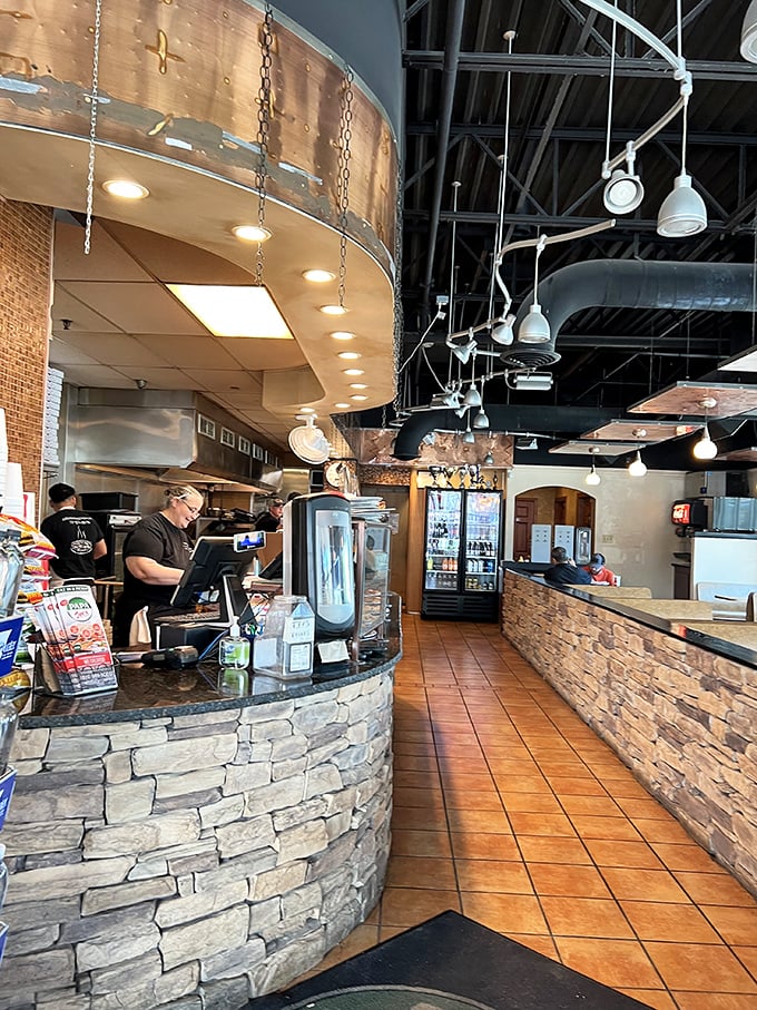 Industrial chic meets pizza parlor practicality. Those pendant lights cast the perfect glow for serious food appreciation.