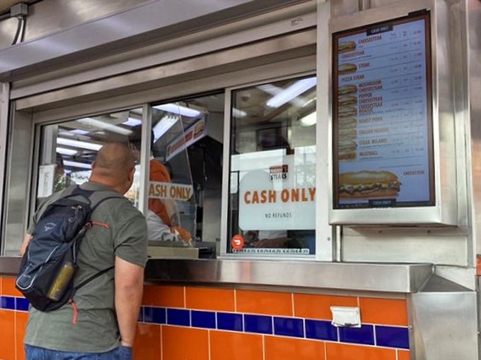 The ordering window&mdash;where dreams come true and tourists learn the local lingo. "Wit or witout" is the password to sandwich paradise.