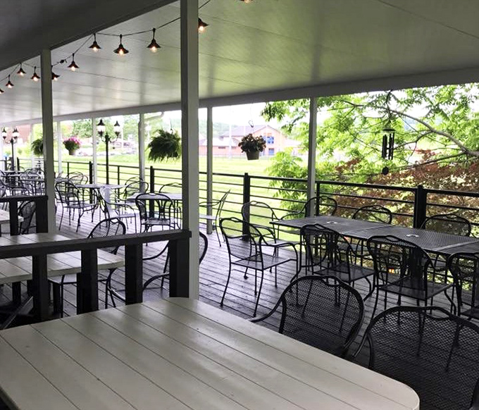 The outdoor patio offers a serene escape with hanging plants and dappled sunlight. Summer evenings here practically demand a milkshake accompaniment.