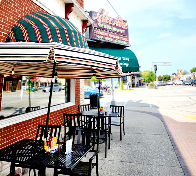 The sidewalk seating offers front-row tickets to Lake Geneva's daily parade of locals and visitors, with awnings providing shade for serious people-watching.