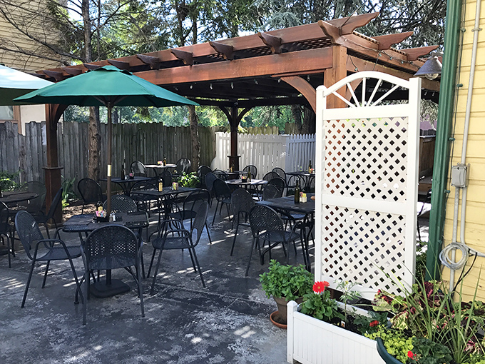 The outdoor patio whispers promises of leisurely brunches under dappled sunlight, where coffee refills and conversation flow freely.